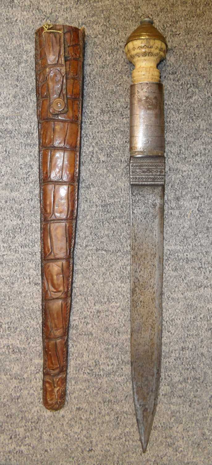 Lot 58 - ËœAN AFRICAN SILVER-MOUNTED DAGGER