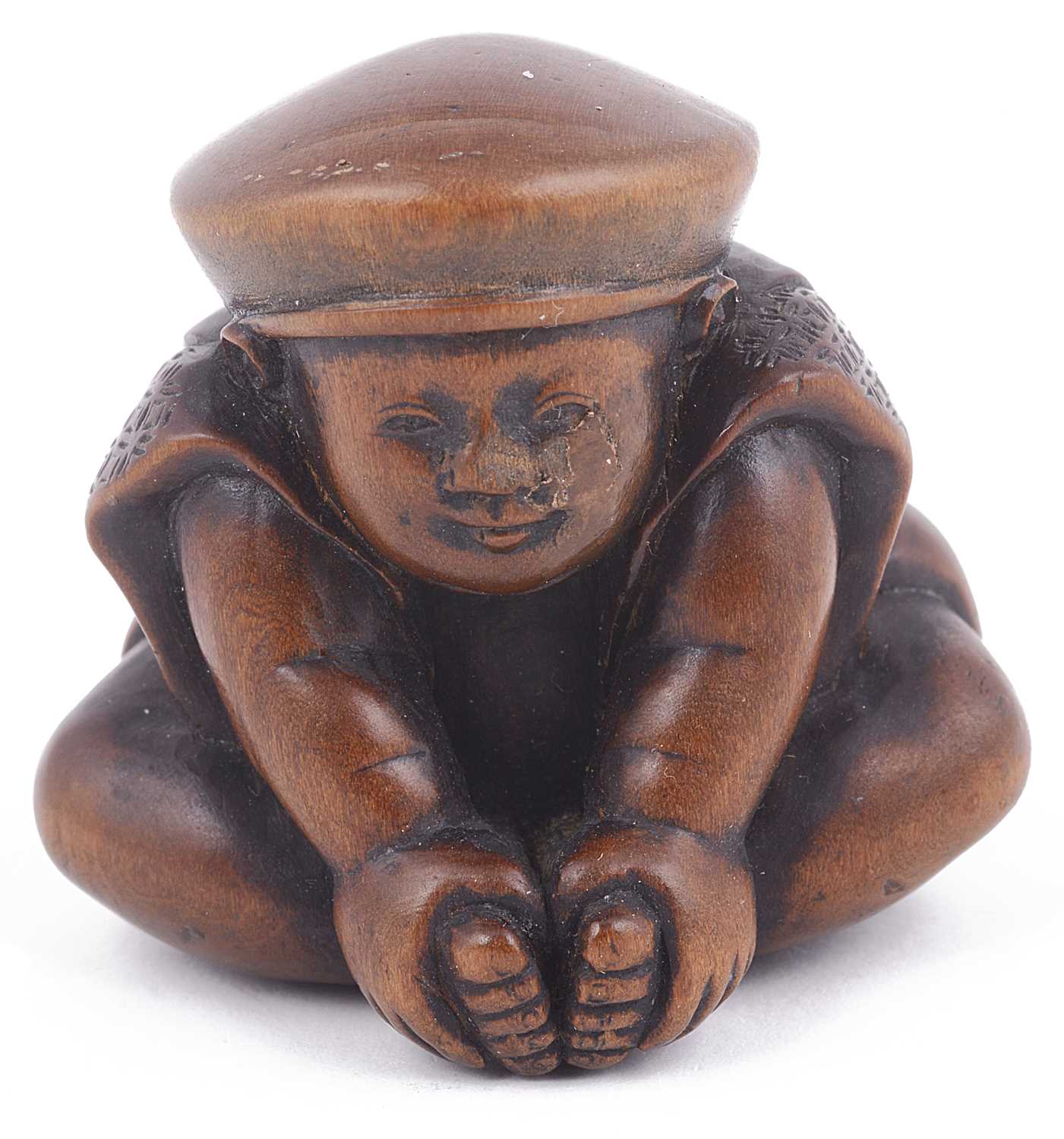 Lot 156 - WOOD NETSUKE OF A BOY WEARING DAIKOKU'S CAP