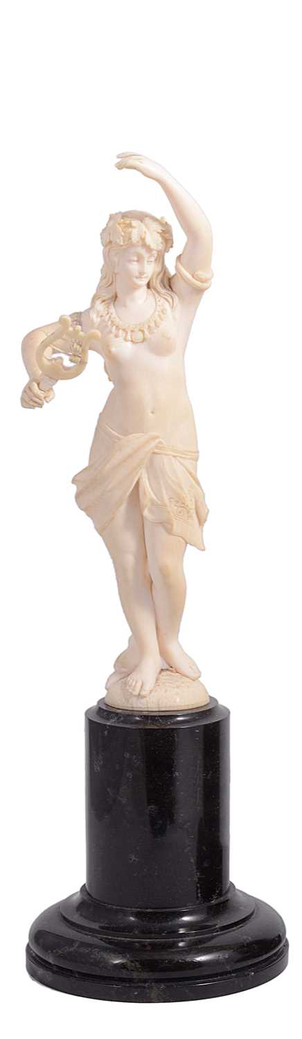 Lot 426 - ~AN IVORY FIGURE OF AN EXOTIC ANCIENT DANCER