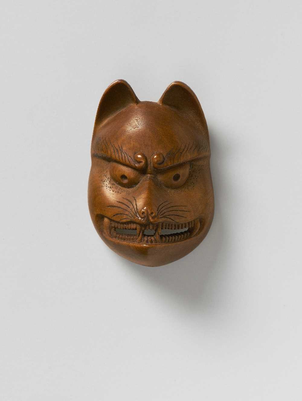 Lot 120 - A JAPANESE MASK NETSUKE OF KITSUNE