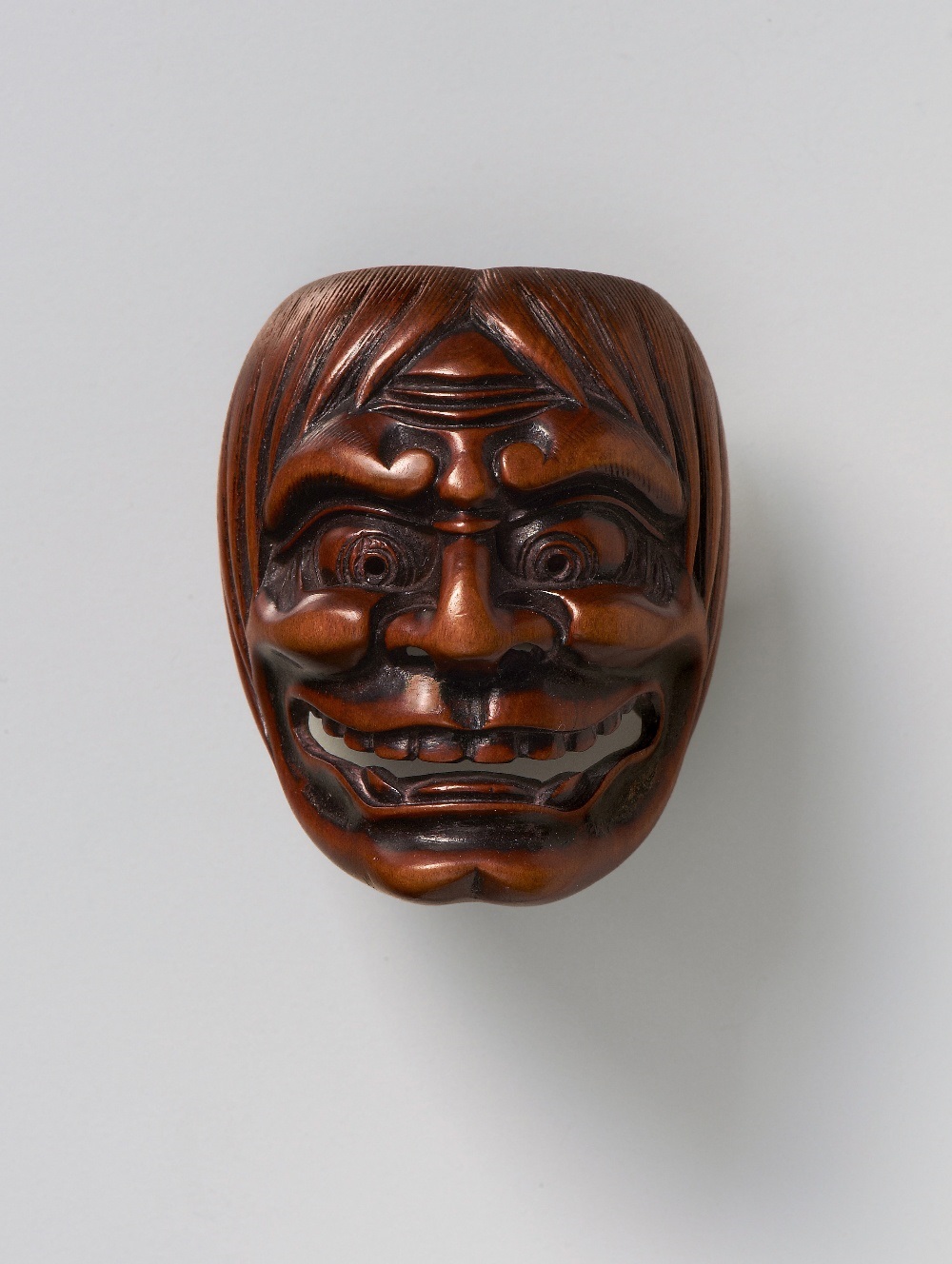 Lot 154 - A JAPANESE MASK NETSUKE OF A DEMON