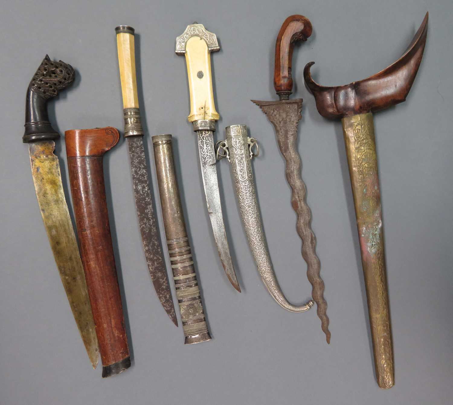 Lot 24 - ËœA BURMESE DHA DAGGER, A MALAYSIAN DAGGER, A