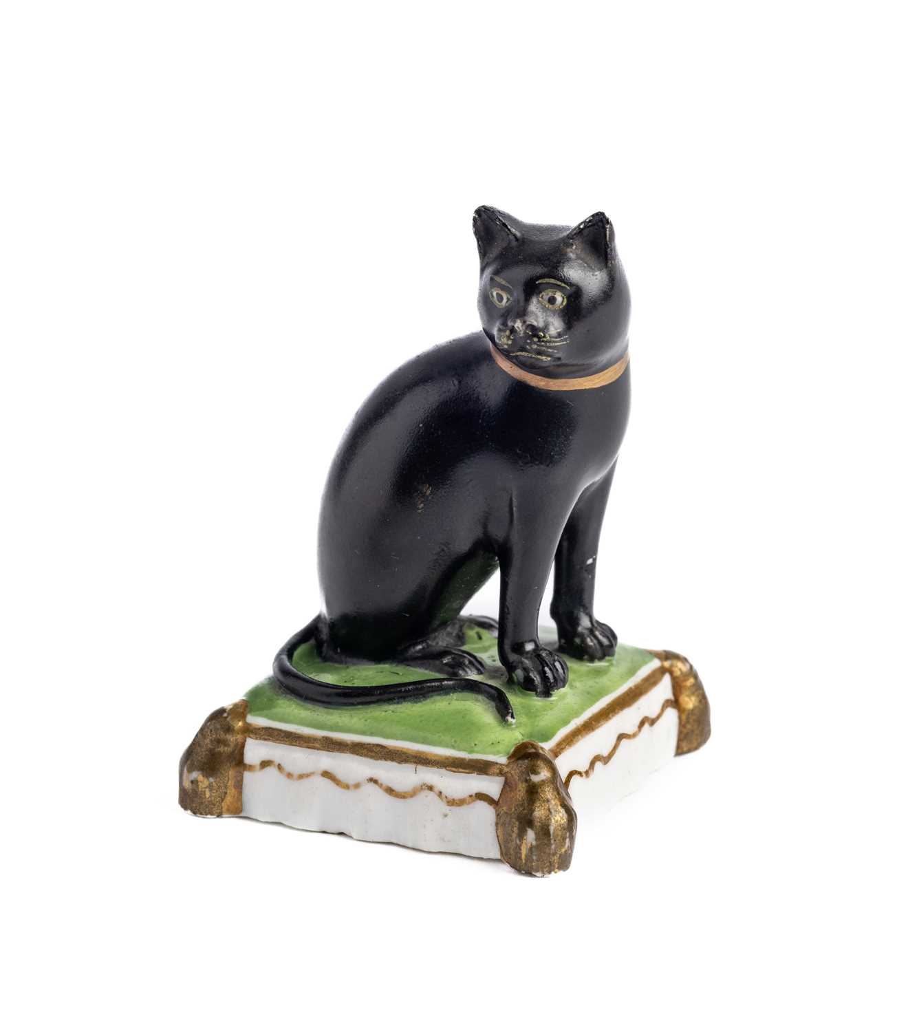 Lot 38 - A ROCKINGHAM PORCELAIN FIGURE OF A CAT, CIRCA