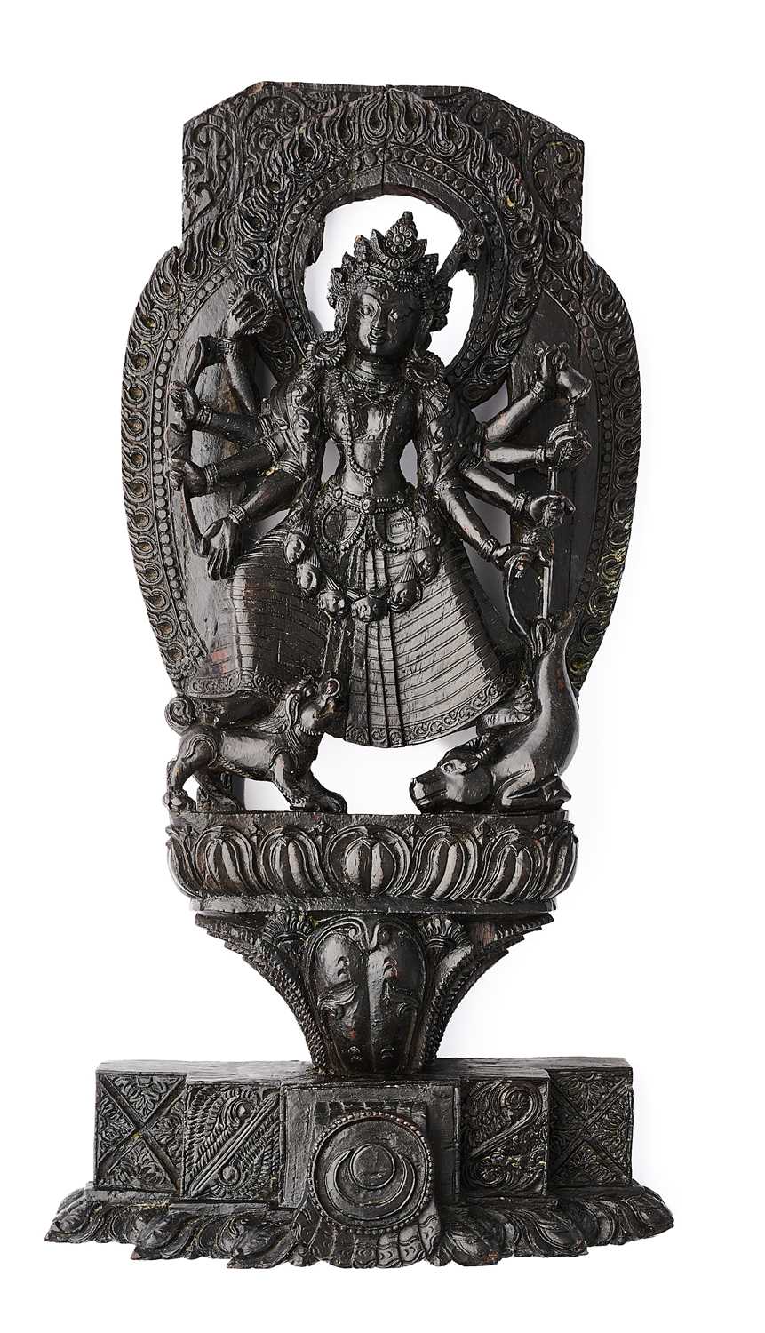 Lot 180 - A CARVED WOOD FIGURE OF DURGA SLAYING THE