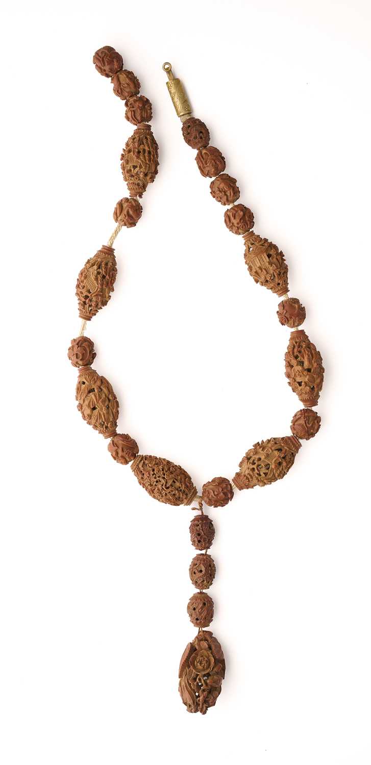 Lot 7 - A CHINESE CARVED HEDIAO NUT SEED NECKLACE,