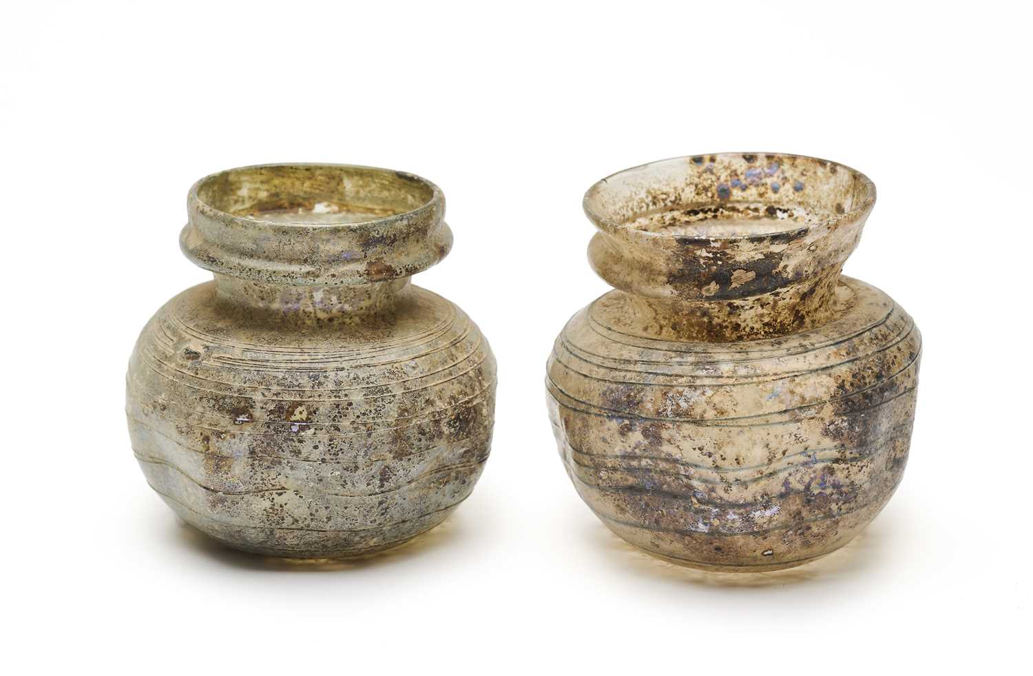 Lot 58 - TWO ROMAN COLOURLESS GLASS JARS, CIRCA 4TH
