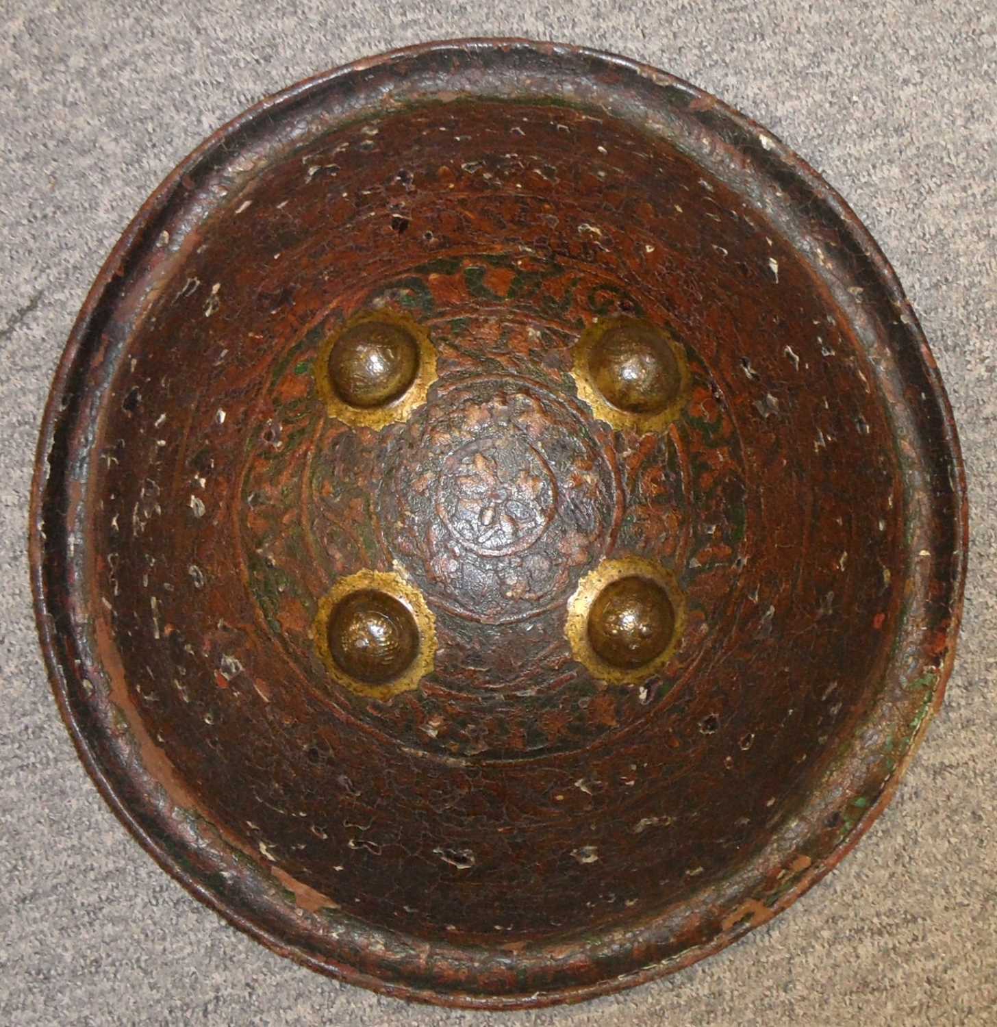 Lot 45 - A PERSIAN LACQUERED HIDE SHIELD (DHAL)